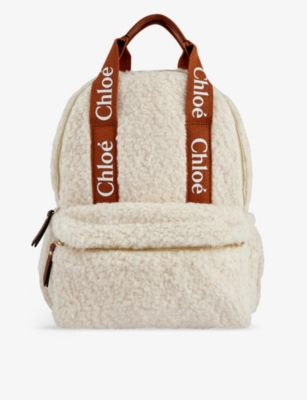 CHLOE - Logo-strap faux-shearling backpack | Selfridges.com